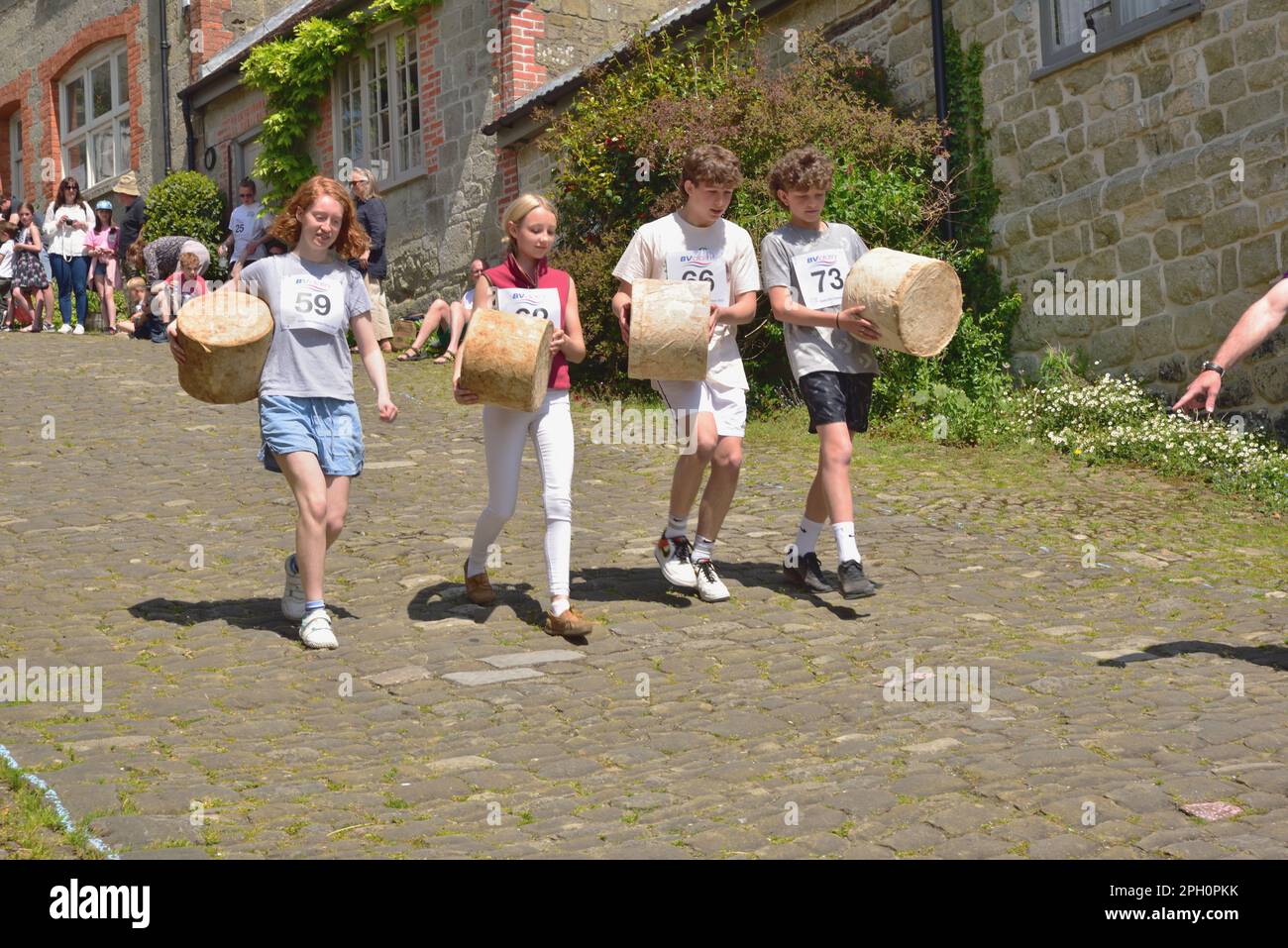 Four children carry their "cheeses" to the start line of the cheese ...
