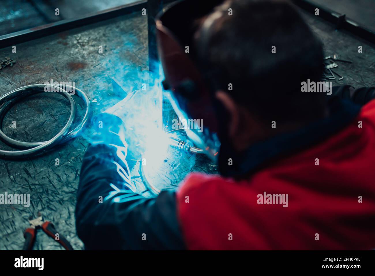 Close up of the steel welding process. Work in the heavy steel industry ...