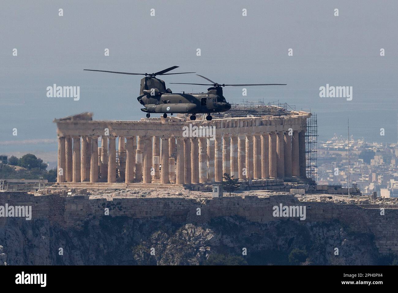 A Greek Chinook military helicopter flies over the Acropolis hill ...