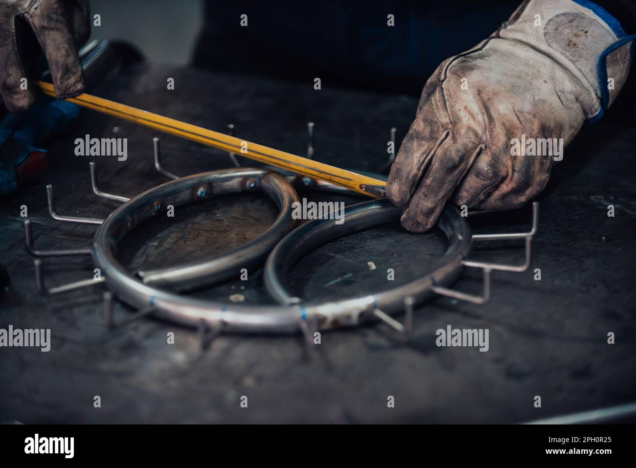 The locksmith measures the pieces of steel and preparing them for ...