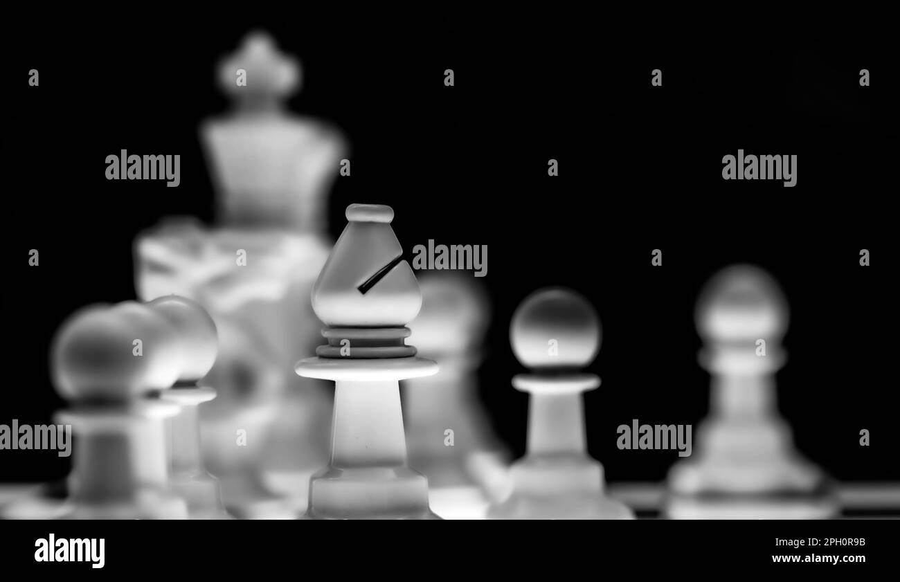 Close up of Chess pieces on a reflective mirror board surface with a ...