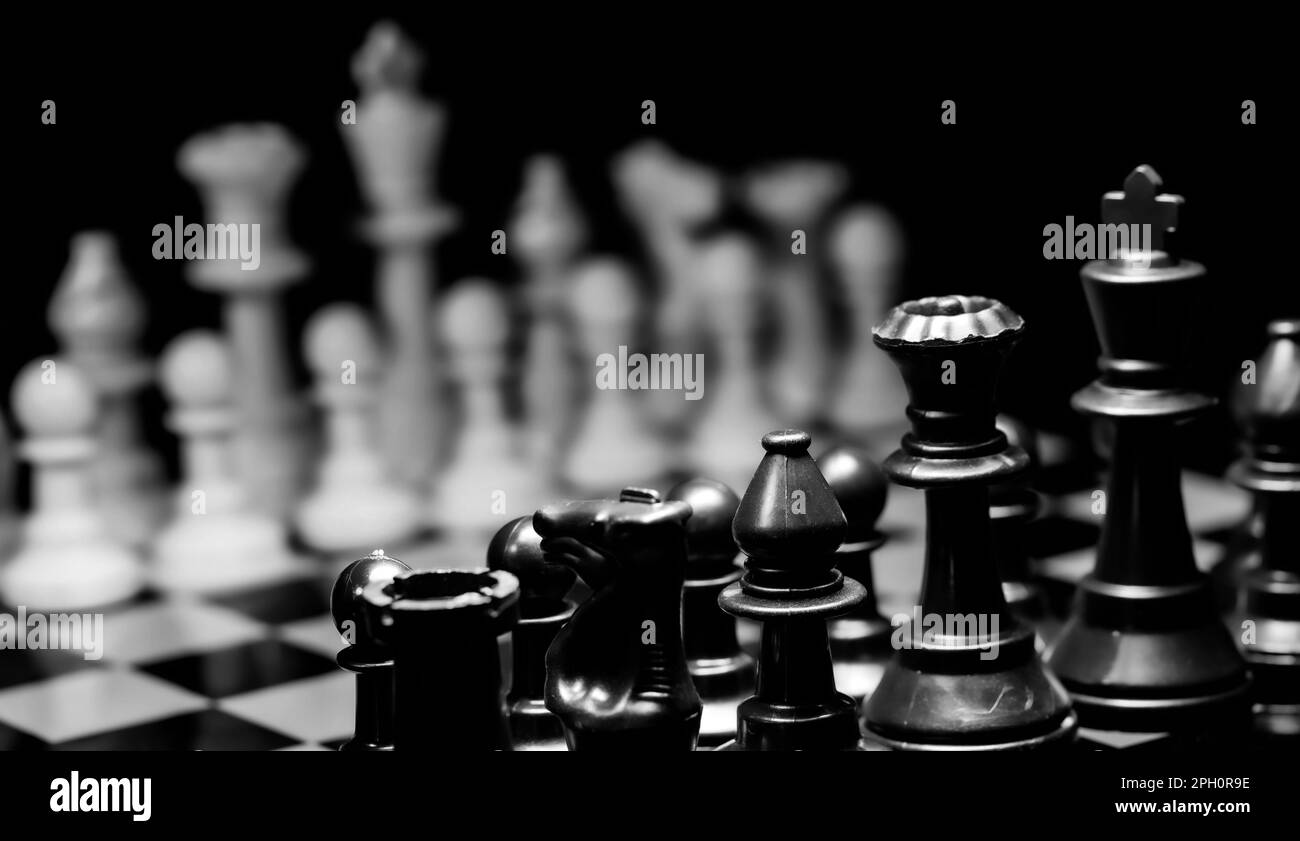 Close up of Chess pieces on a reflective mirror board surface with a ...