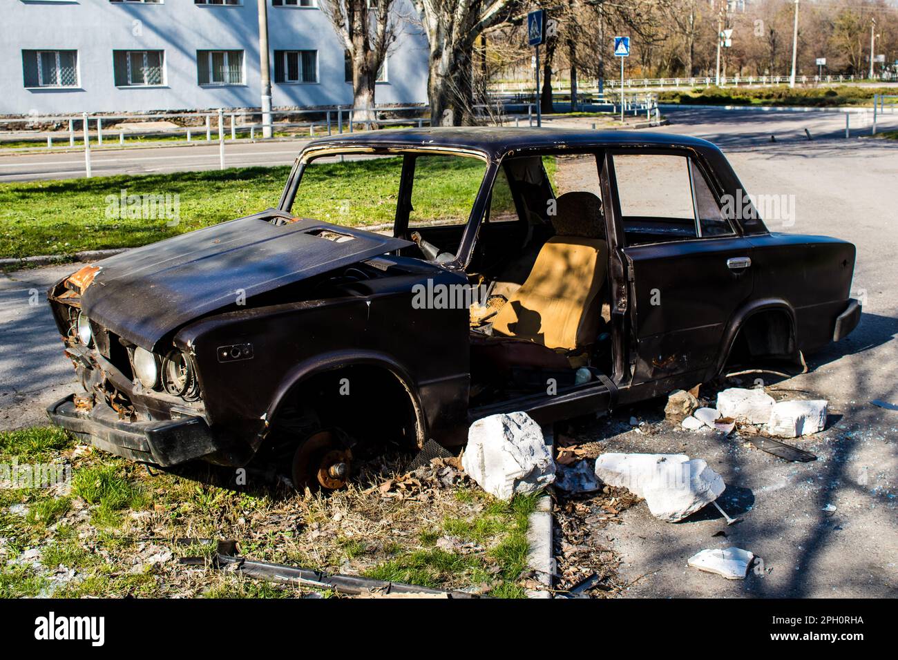 Car that completely destroyed on the streets of Kherson. Russian shelling of the city is ...