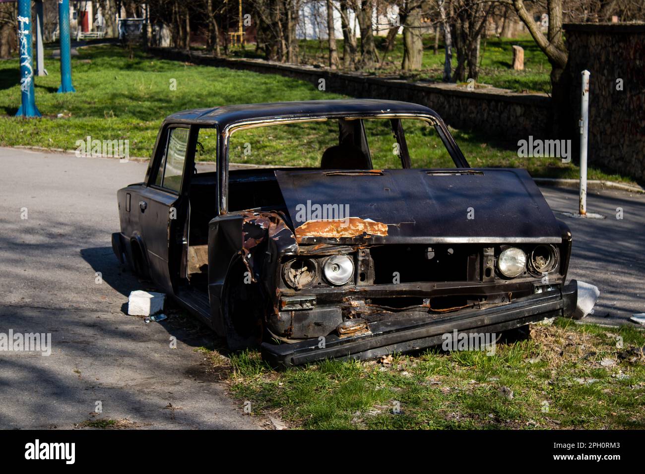 Car that completely destroyed on the streets of Kherson. Russian shelling of the city is ...