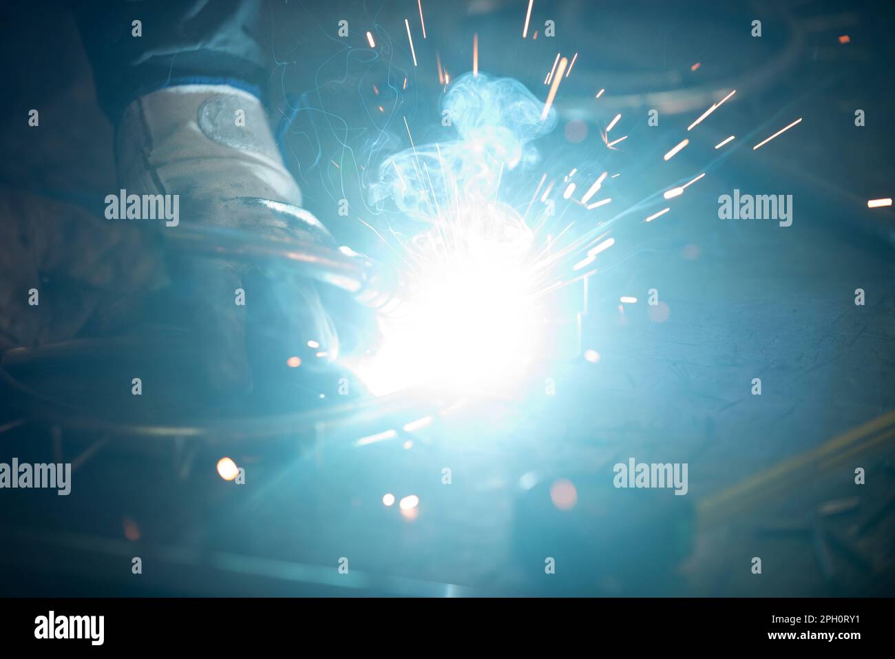 Close up of the steel welding process. Work in the heavy steel industry ...