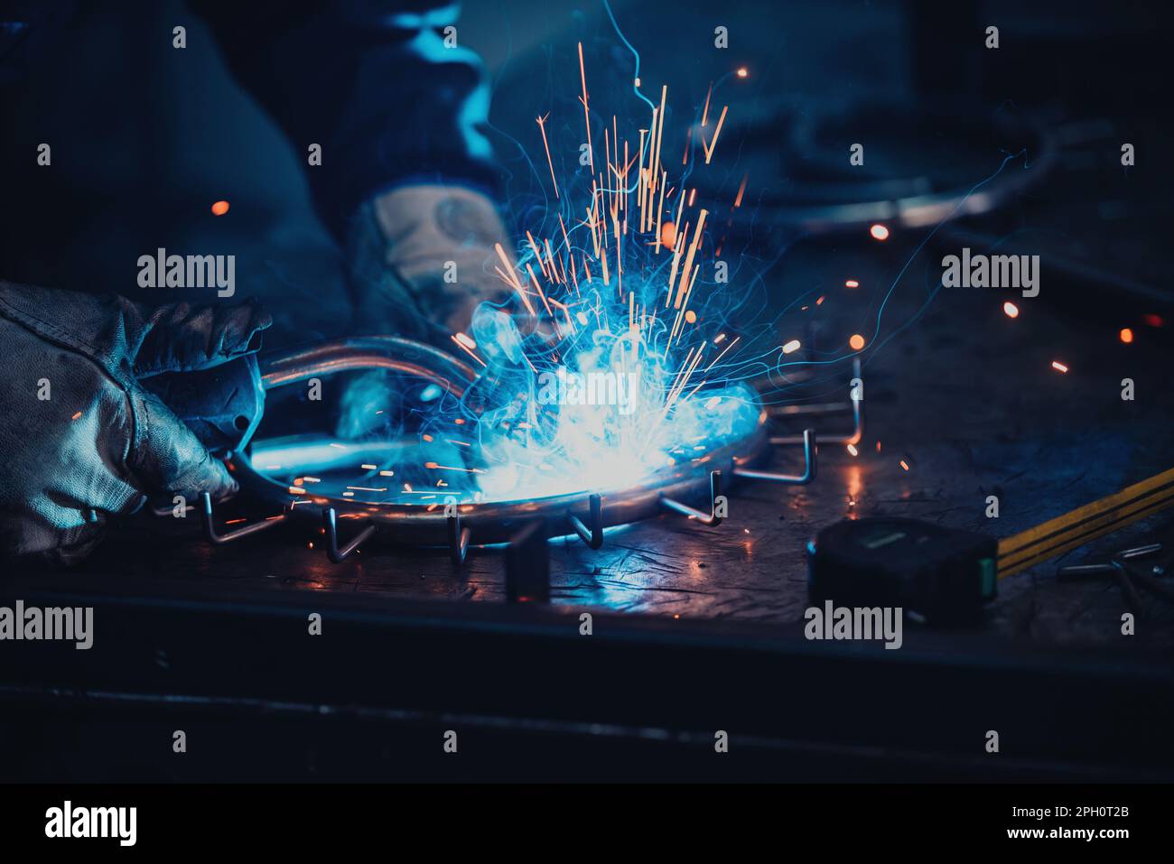 Close up of the steel welding process. Work in the heavy steel industry ...