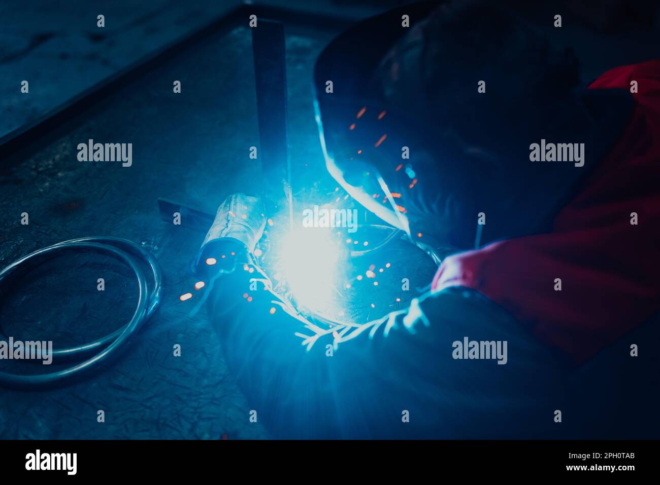 Close up of the steel welding process. Work in the heavy steel industry ...
