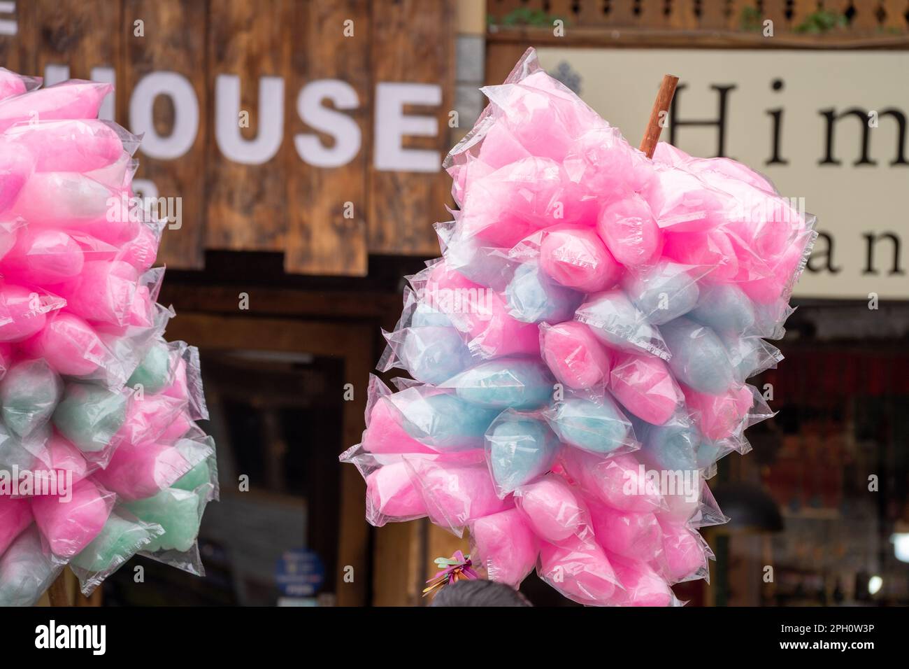 cotton candy being sold in small poly bags mounted on a stick making a ...