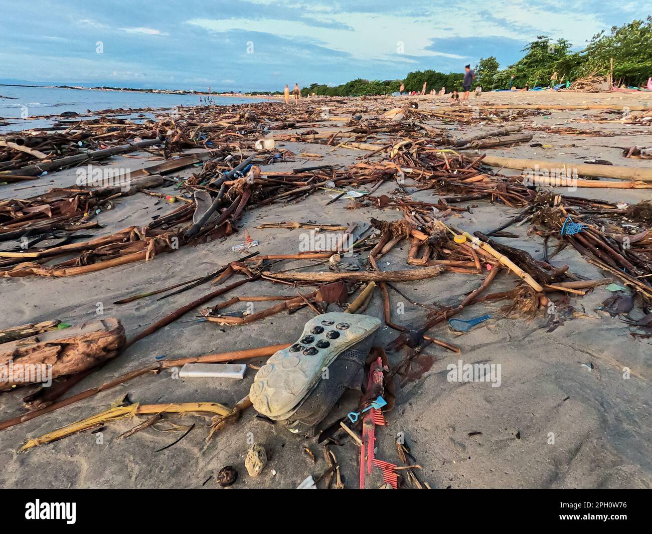 Garbage washed up on the beach from the ocean after high tide. An ...