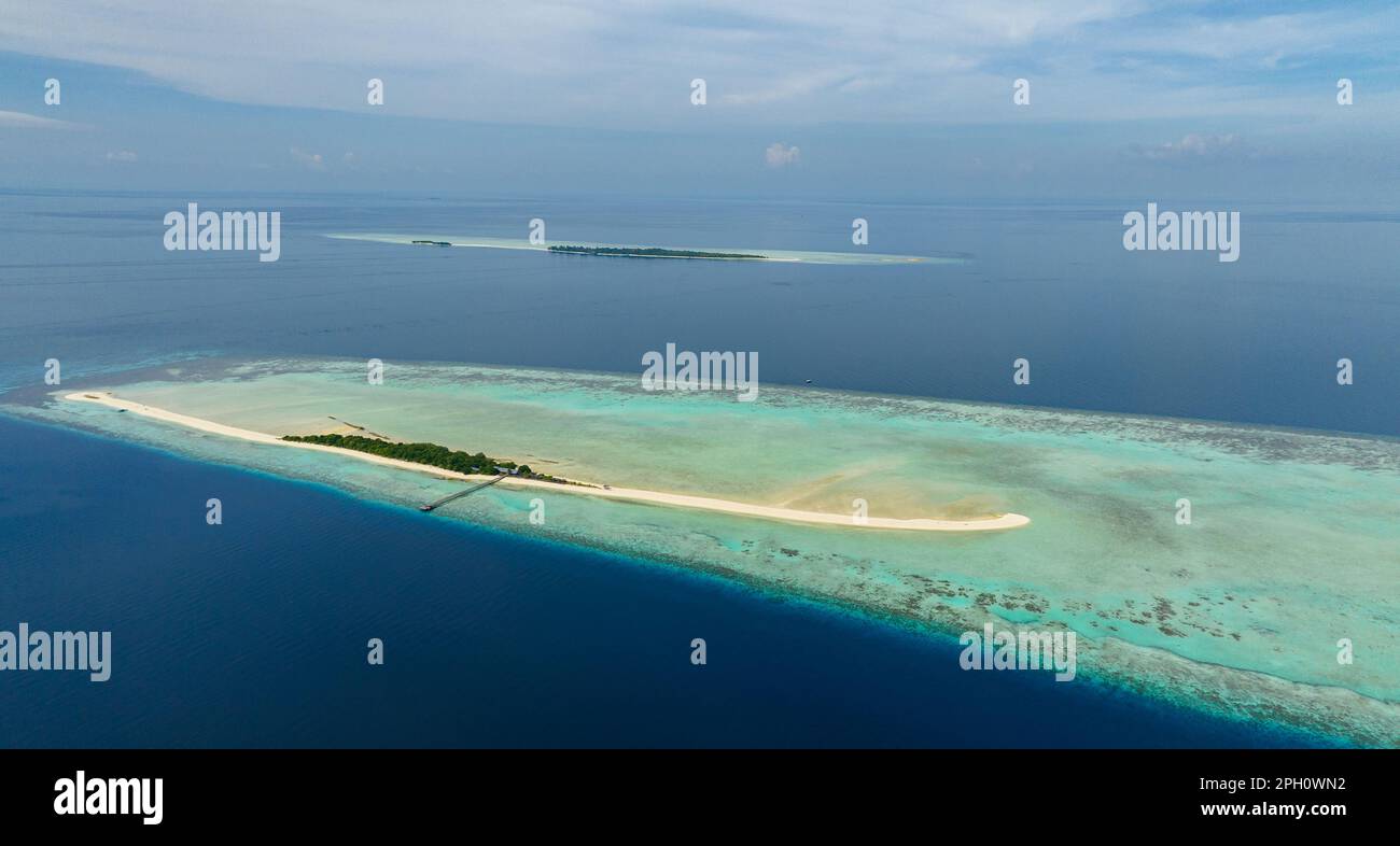 Aerial view of tropical island on the atoll and coral reef. Timba Timba ...