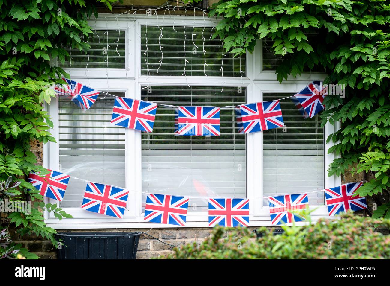 Union Jack flags hanging on a window. British holiday concept Stock ...