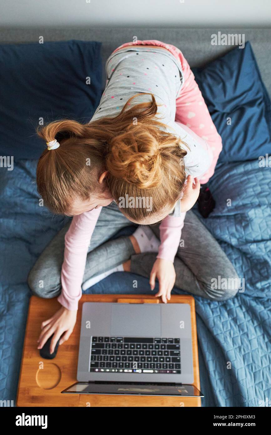 Grandchildren teenage girl and her younger sister talking on video call ...