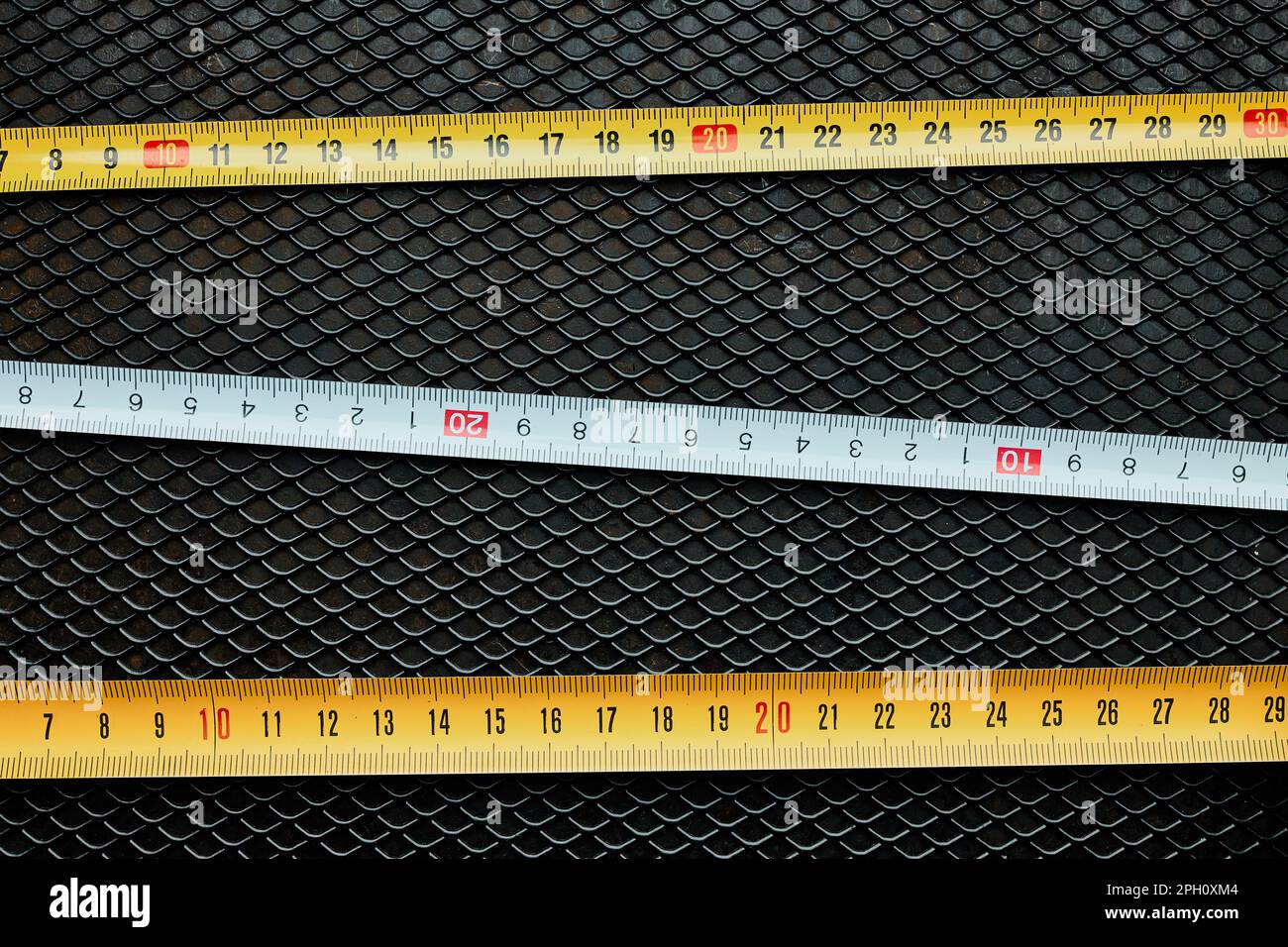 Steel tape measure. Measuring tool on metal surface. Technical ...