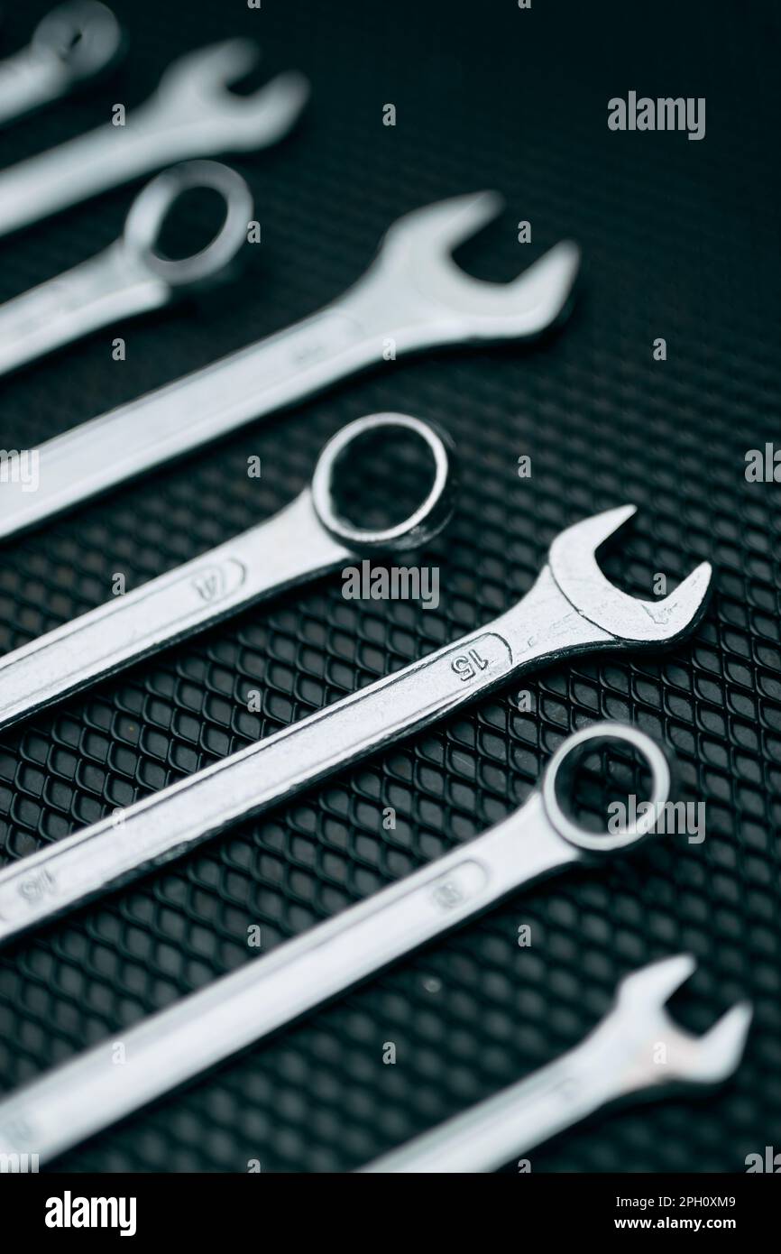 Set of chrome wrenches on steel surface. Mechanic tools for maintenance ...