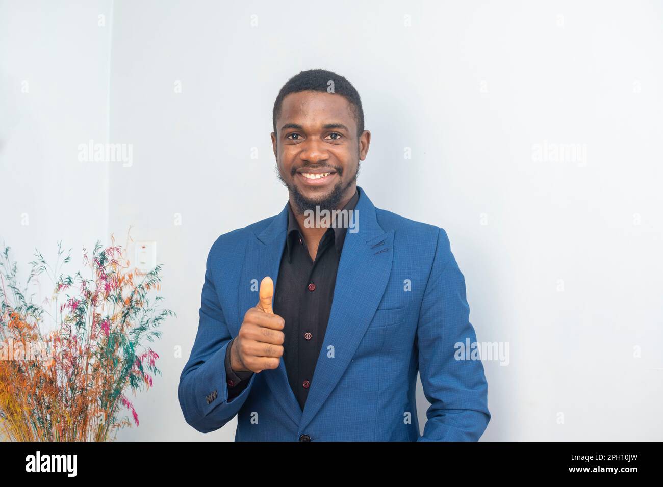 african businessman does thumbs up gesture Stock Photo - Alamy