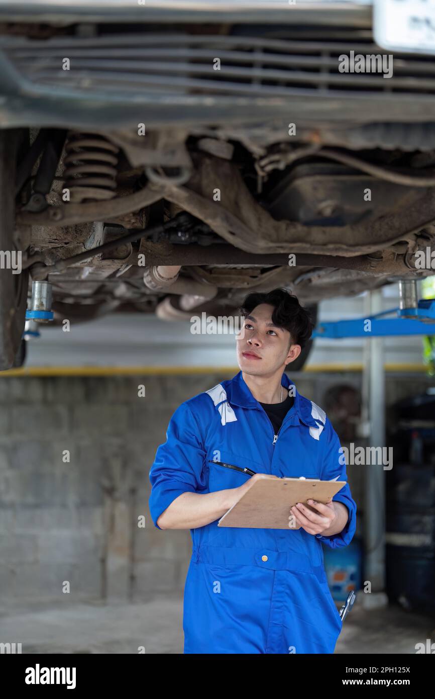 Vehicle service maintenance asian man checking under car condition in ...