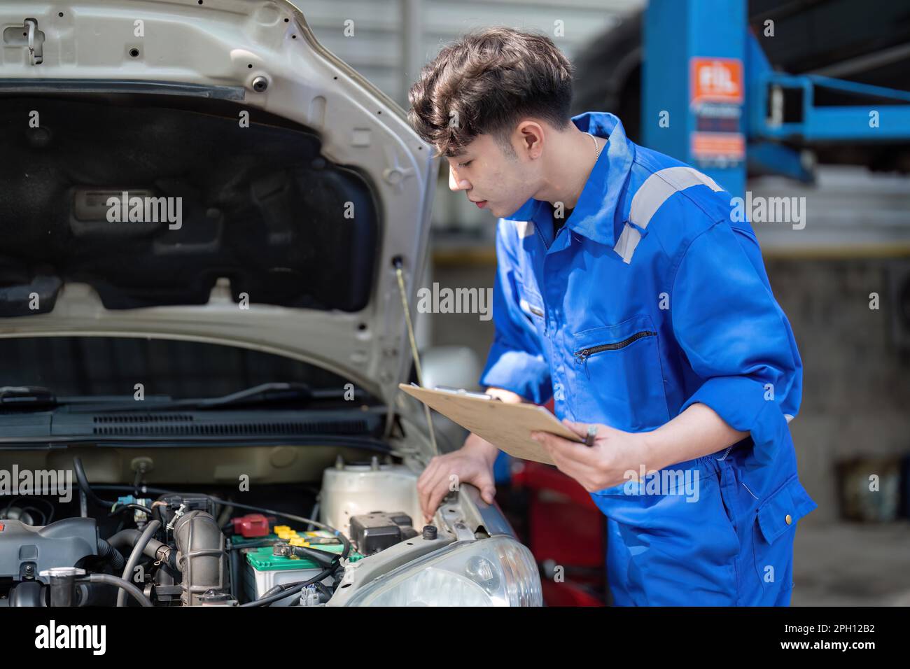 Vehicle service maintenance asian man checking under car condition in ...