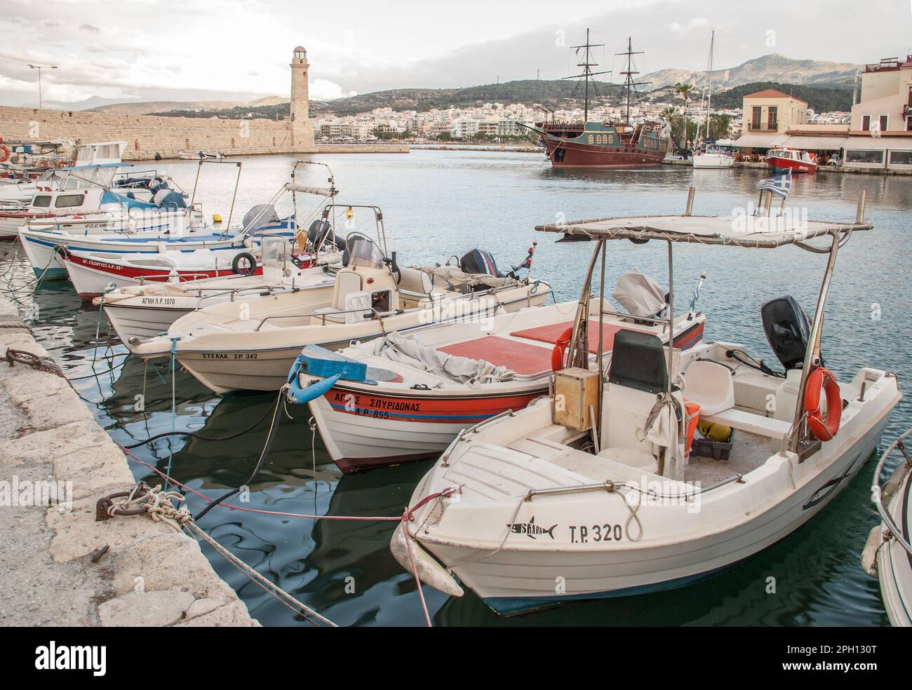 Harbour scene at Rethymnon,Crete with the lighthouse, Barbarosa pirate ...