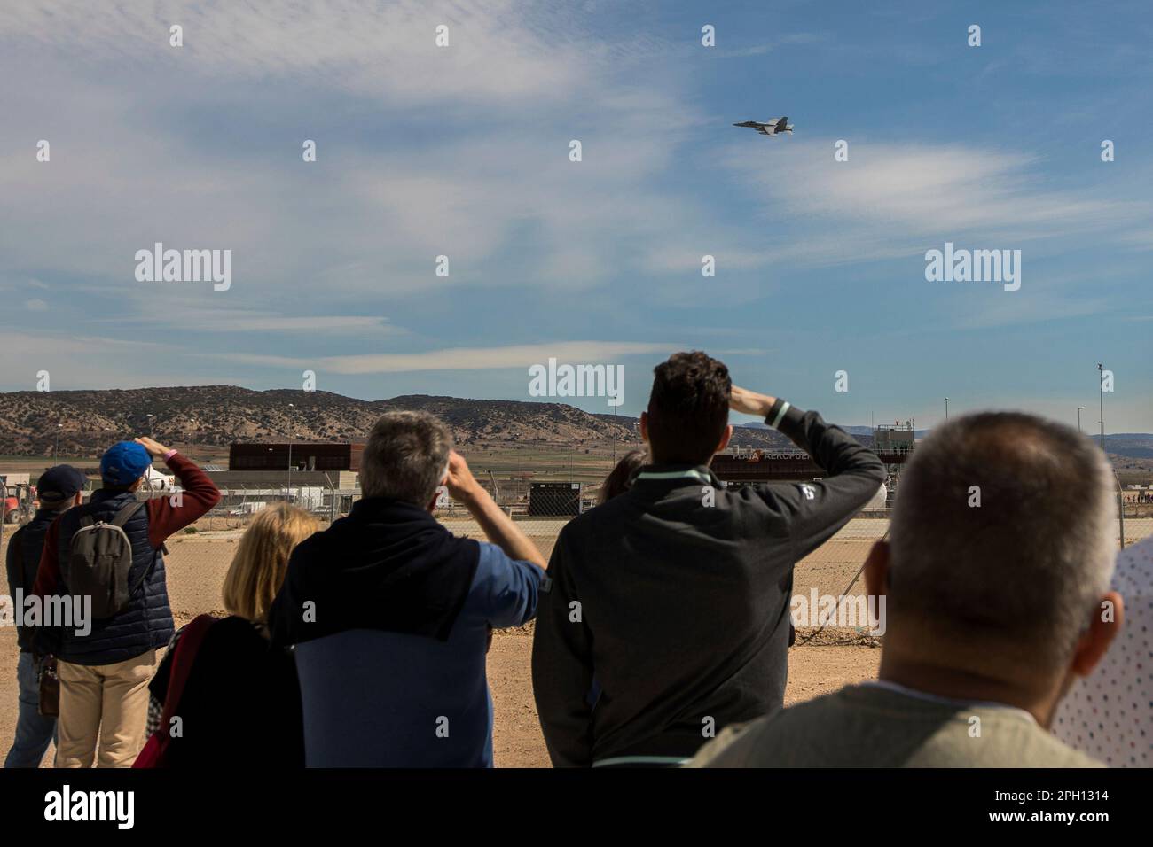 Several people watch an aircraft during the institutional act of ...