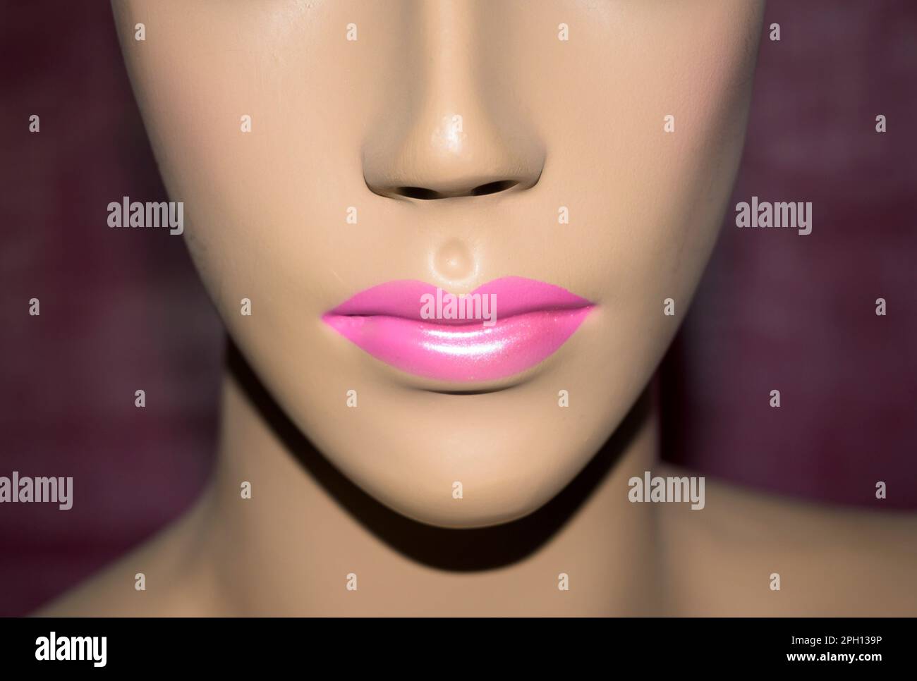 half face of woman mannequin with nose, mouth and lips painted pink ...