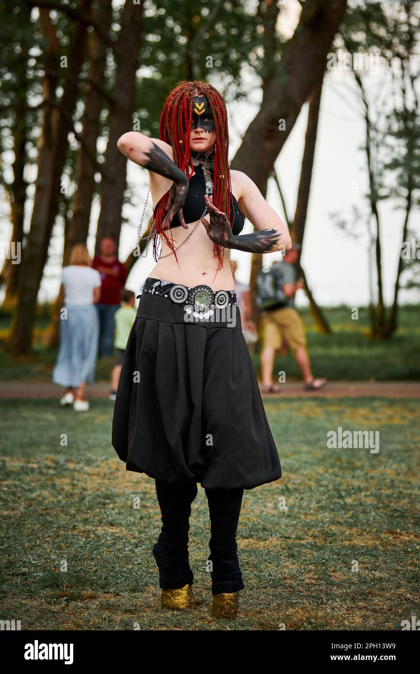 Mythological dancing girl faun on green lawn in public park outdoor art ...