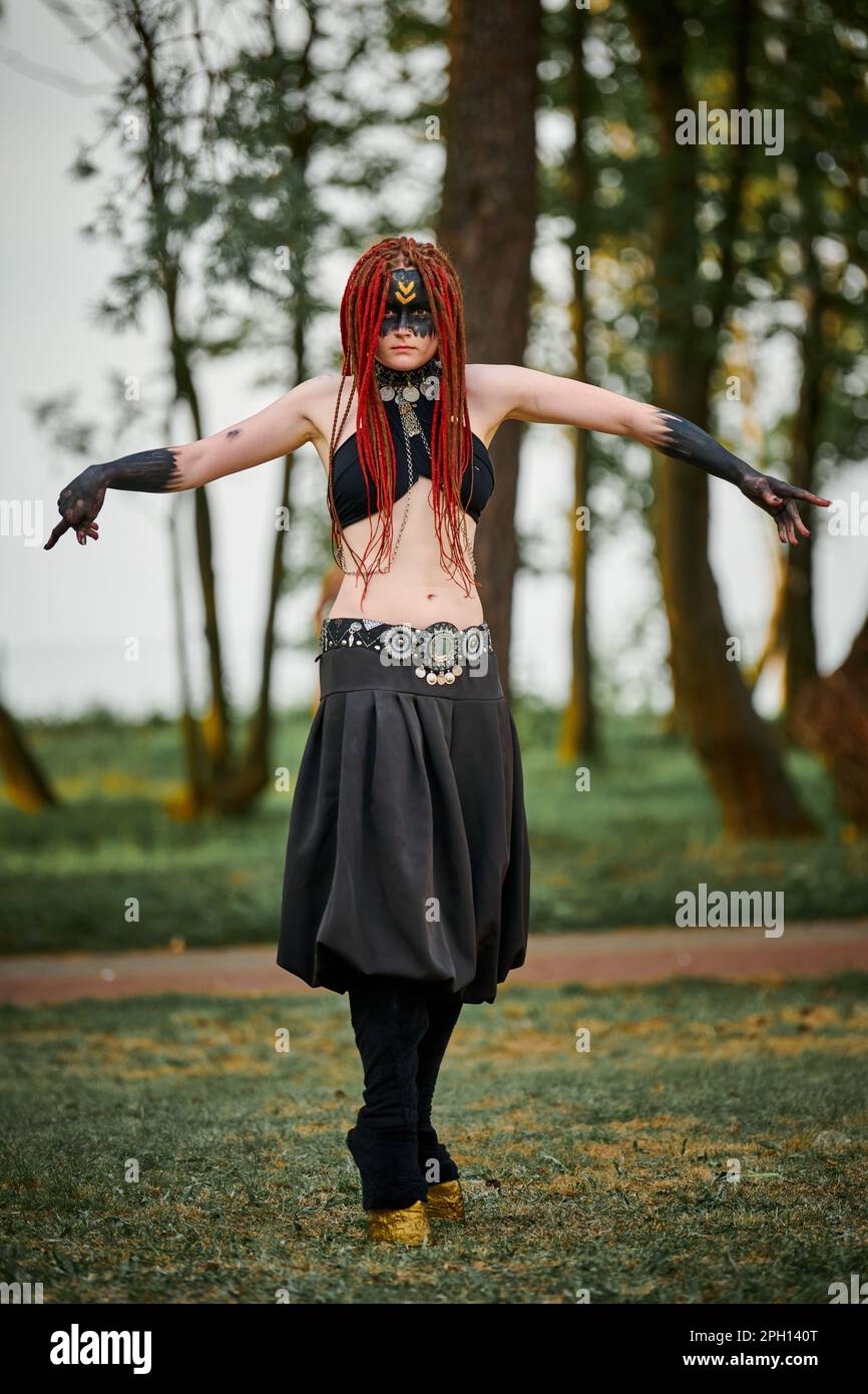 Mythological dancing girl faun on green lawn in public park outdoor art ...