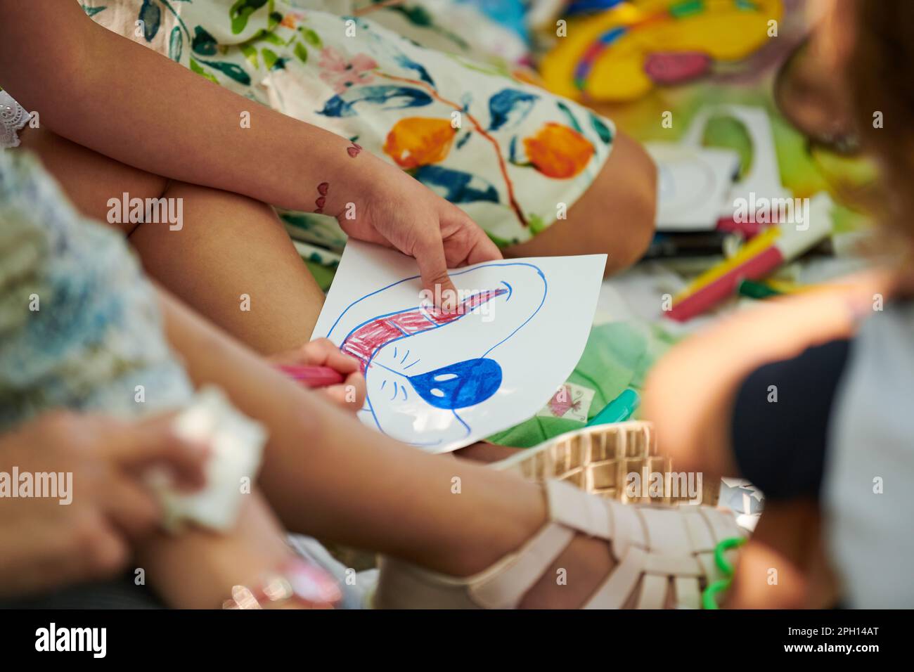Children paper crafting with parents in outdoor children party ...