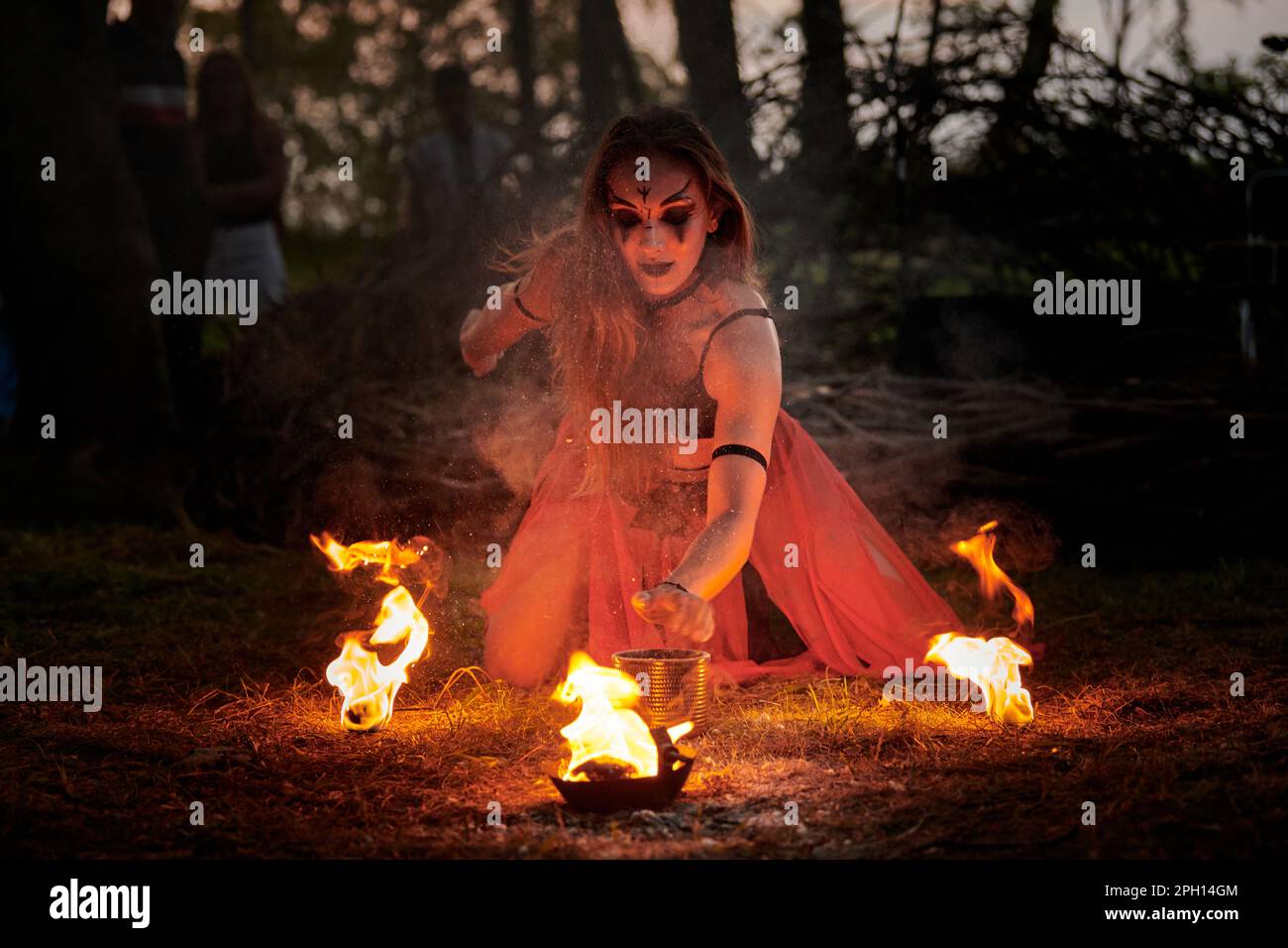 Girl fire dancing performance at outdoor art festival, smooth movements ...