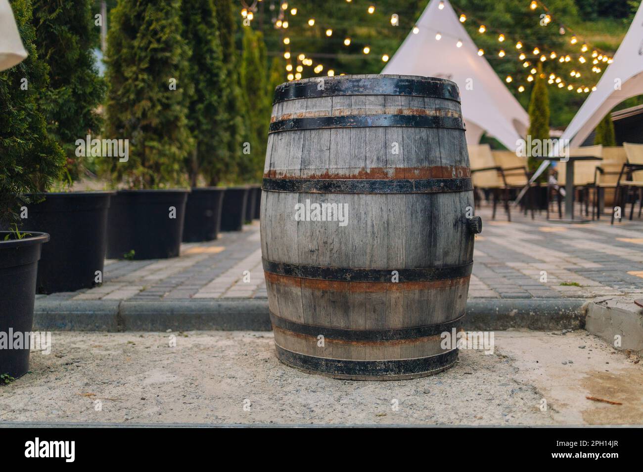 A wooden barrel stands on the cafe terrace Stock Photo - Alamy