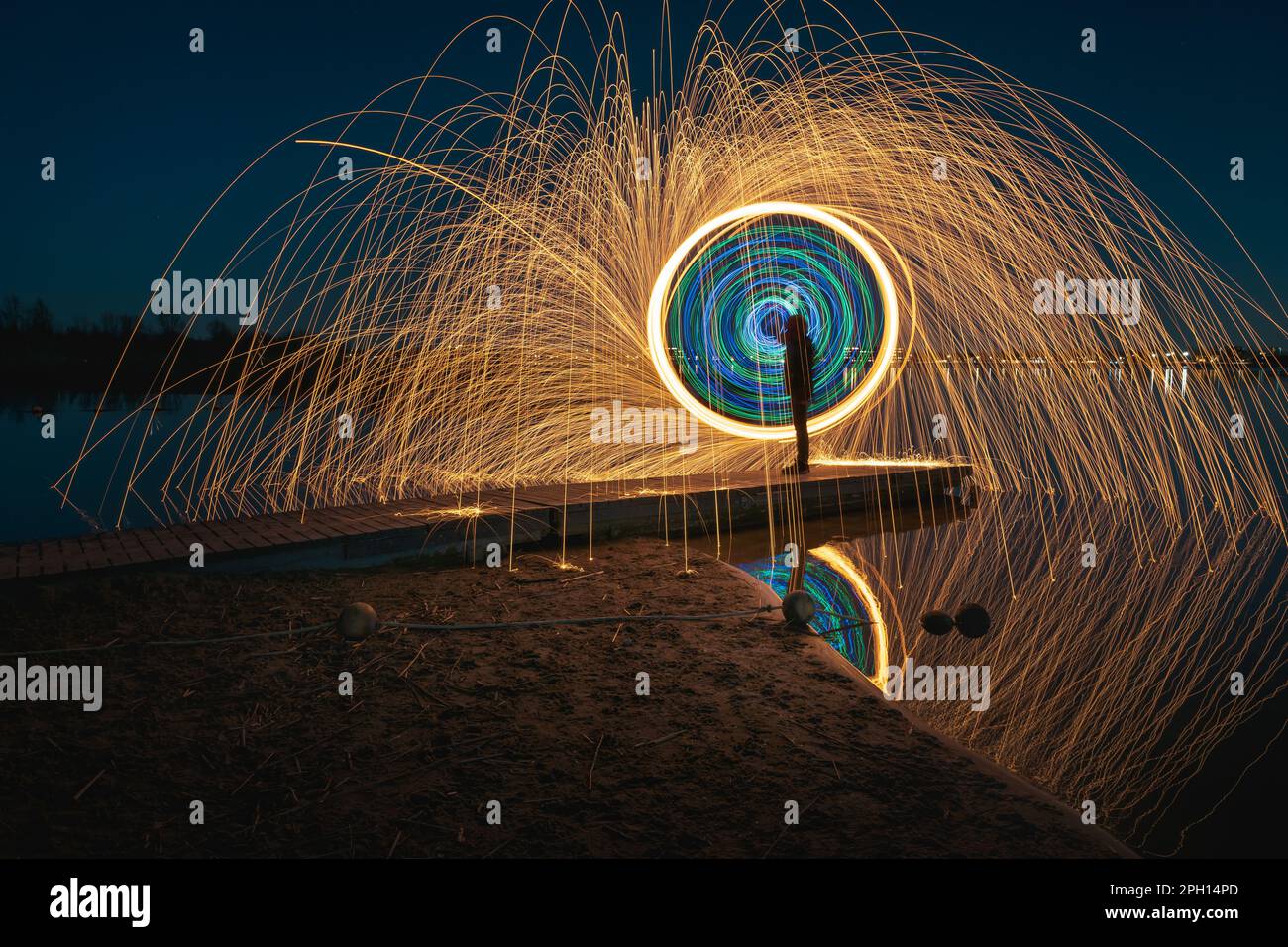 Burning steel wool spinned in urban area. Showers of glowing sparks ...