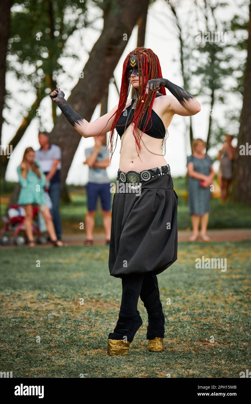 Mythological dancing girl faun on green lawn in public park outdoor art ...