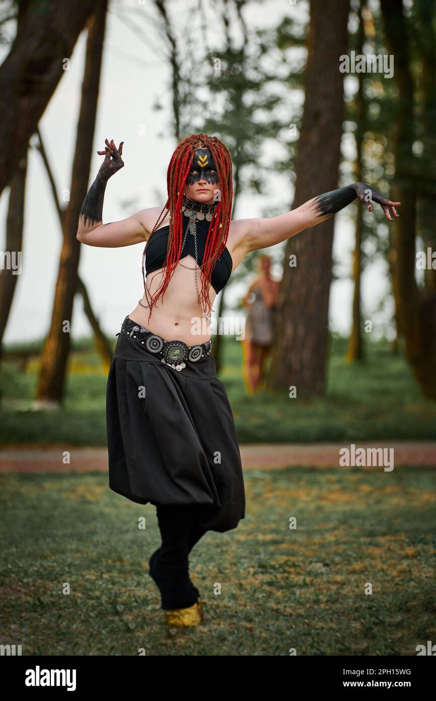 Mythological dancing girl faun on green lawn in public park outdoor art ...