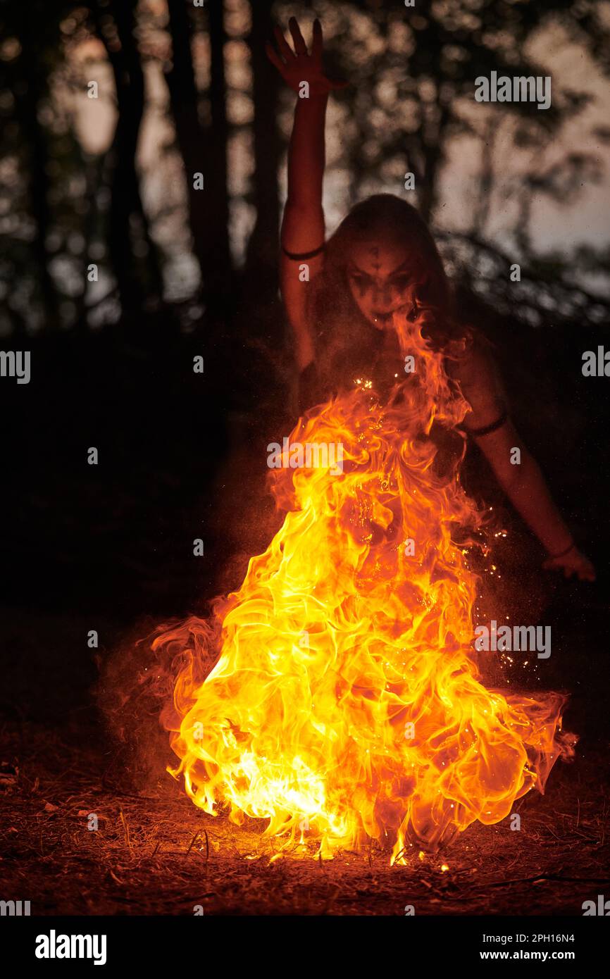 Girl fire dancing performance at outdoor art festival, smooth movements ...