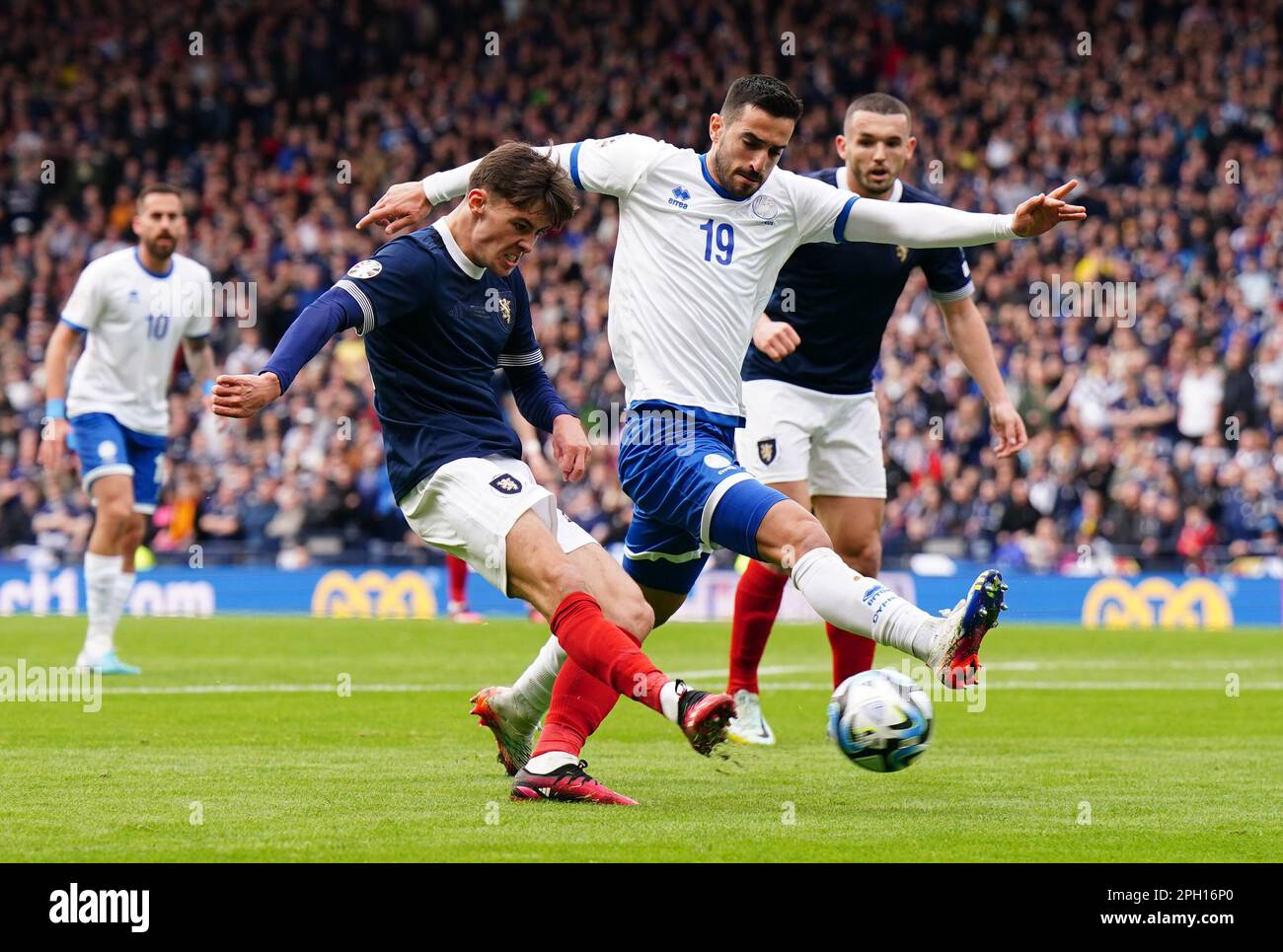 Scotland's Aaron Hickey (left) shoots, under pressure from Cyprus ...