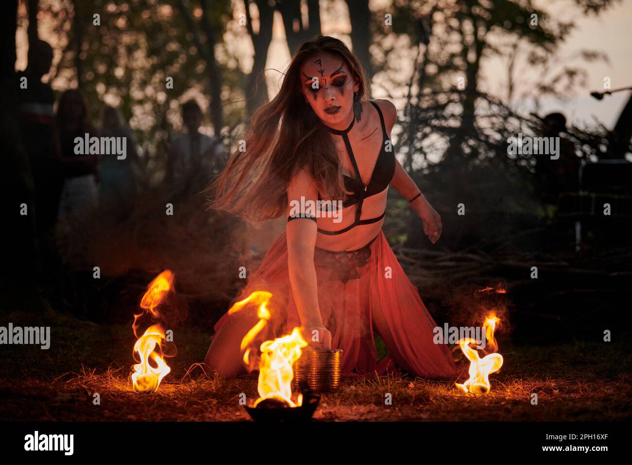 Girl fire dancing performance at outdoor art festival, smooth movements ...