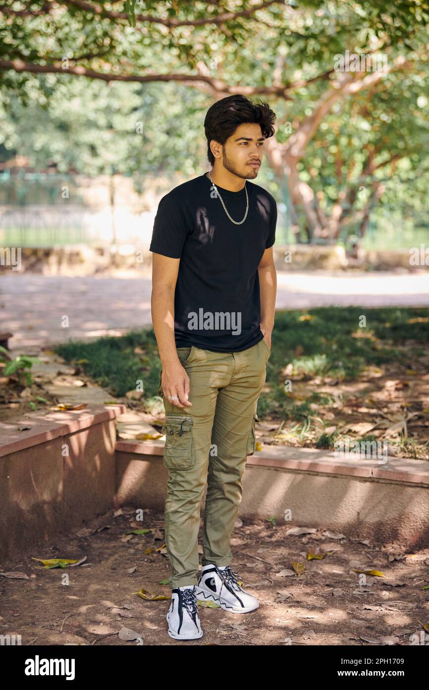 Attractive young indian man full height portrait in black t shirt and ...
