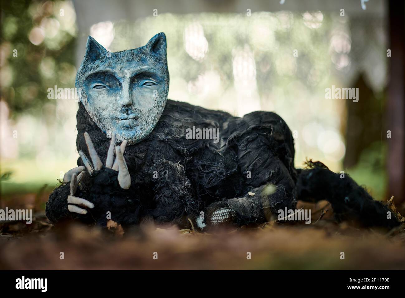 Black Cat In Human Face Mask Art Object At Outdoor Art Exhibition In