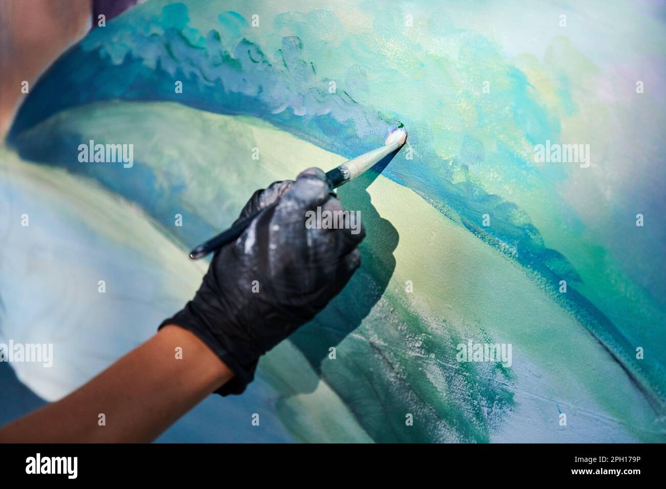 Girl artist hand holds paint brush and draws surreal fairy tale ...
