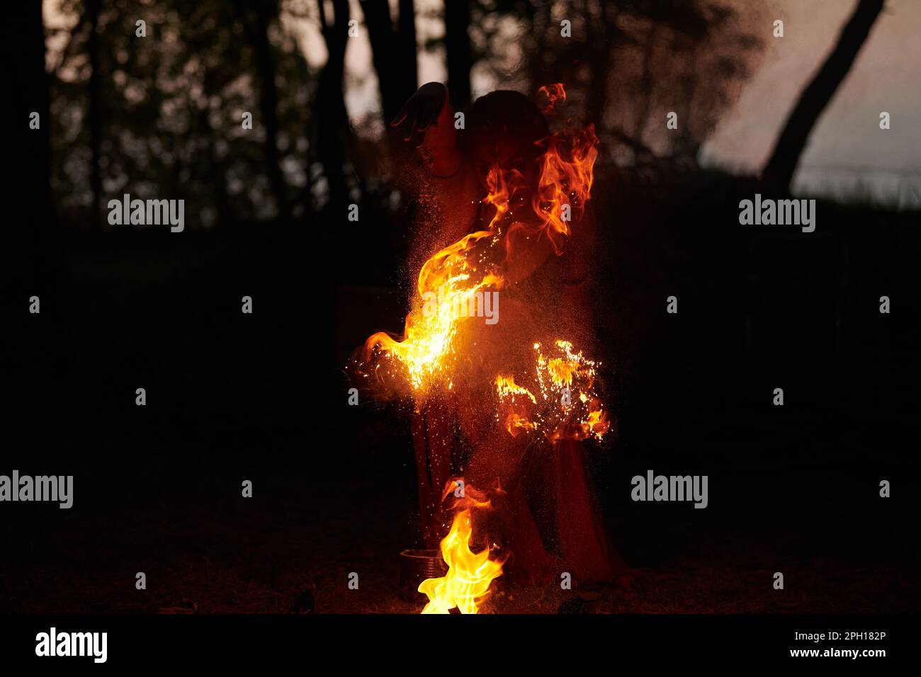 Girl fire dancing performance at outdoor art festival, smooth movements ...