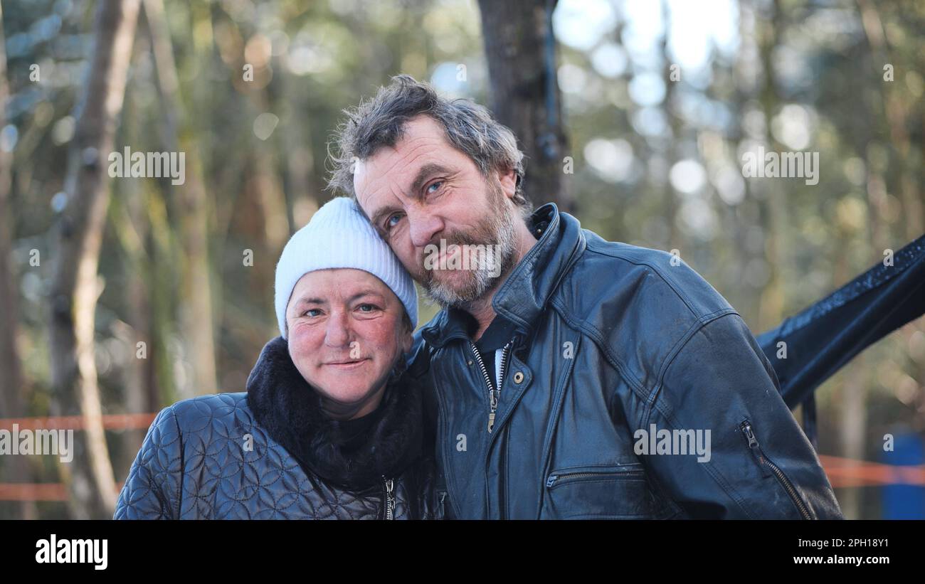 A homeless woman and a man pose in the woods in winter Stock Photo - Alamy