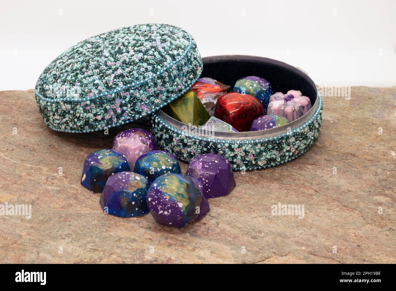 round box of chocolates design on a stone and white background Stock ...