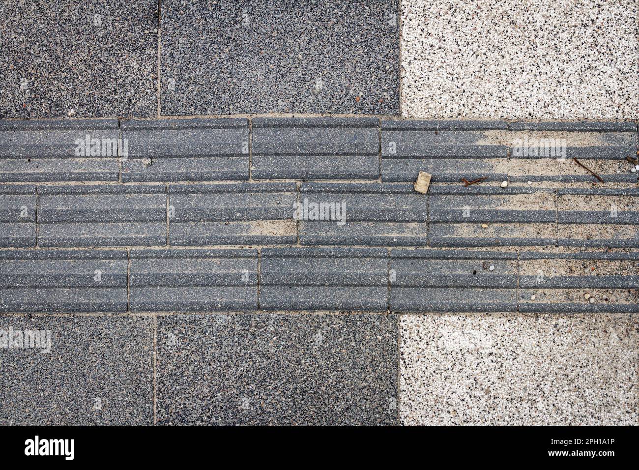 Textured walkway for blind people. Black tactile paving for the ...