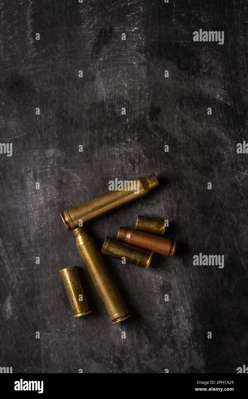 Empty bullet cartridges lying on the black background Stock Photo - Alamy