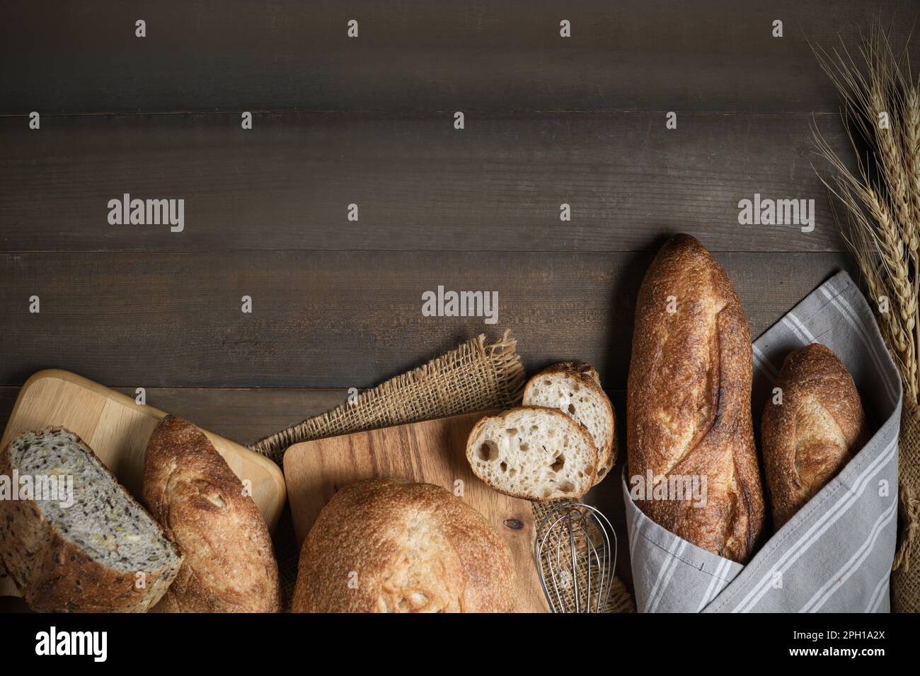 slide multi grain sourdough bread and sliced Baguette on wood ...