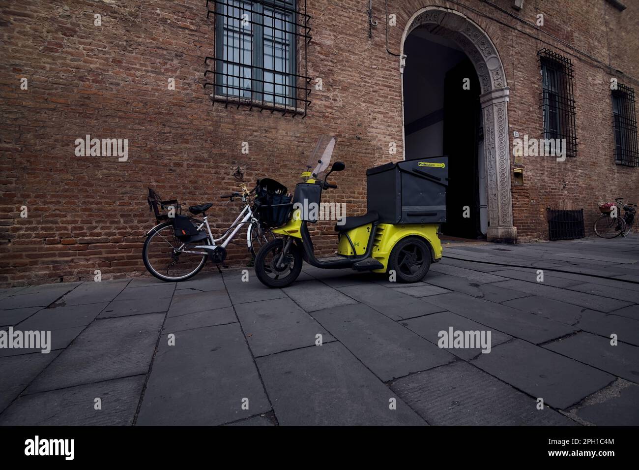 Bike of italian mail service parked on the pavement in front of a ...