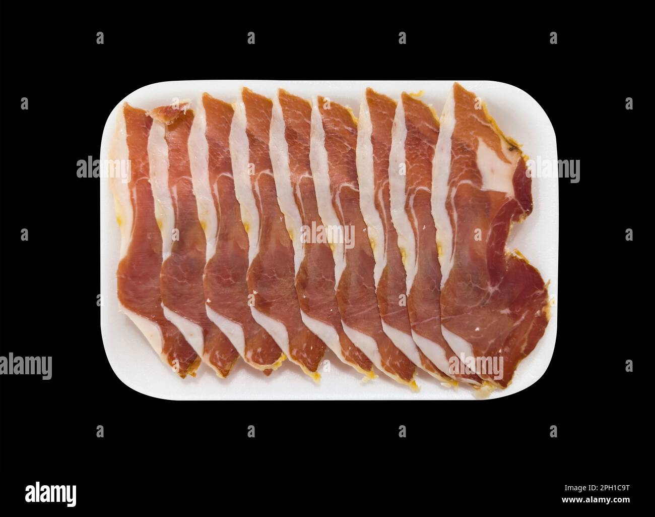 Jamon serrano. A Spanish ham isolated on black background. Traditional ...