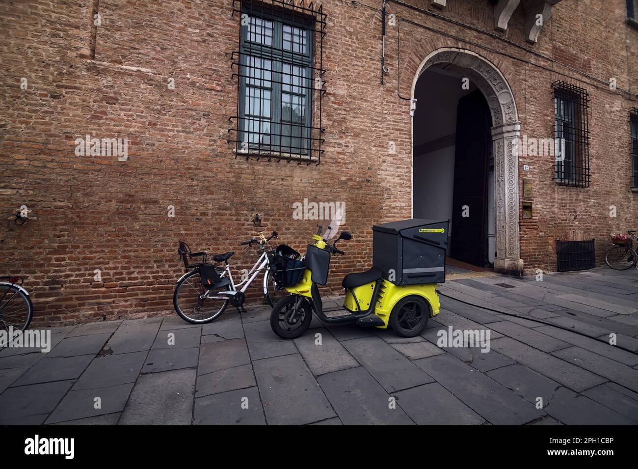 Bike of italian mail service parked on the pavement in front of a ...