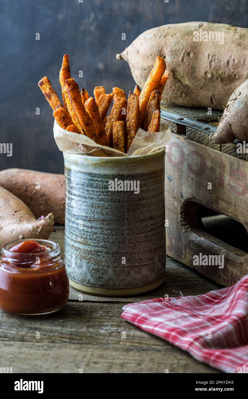Sweet potato fries in clay dish. Close up, portrait Stock Photo - Alamy