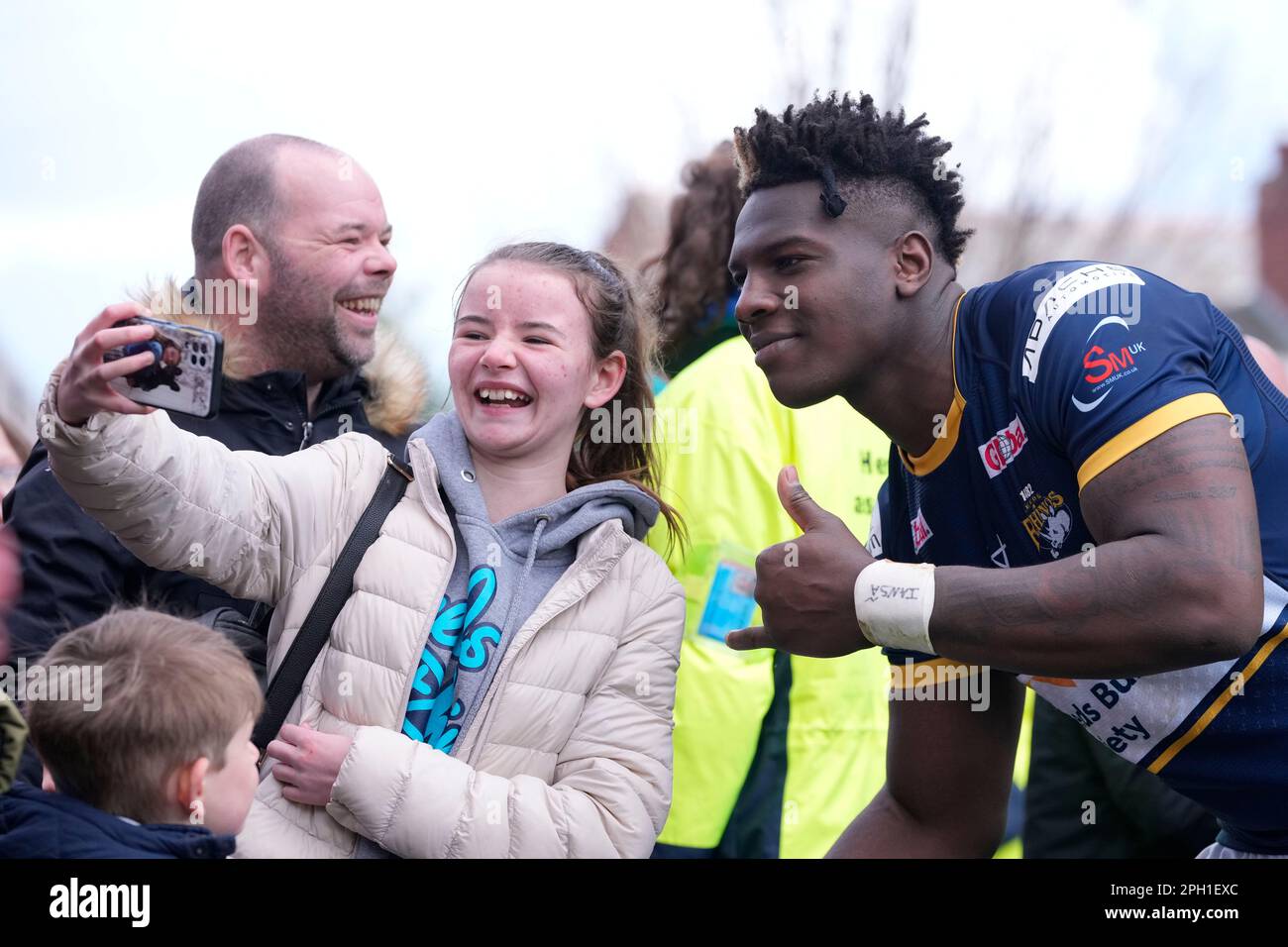 Justin Sangare #17 of Leeds Rhinos poses for a selfie with a fan after ...