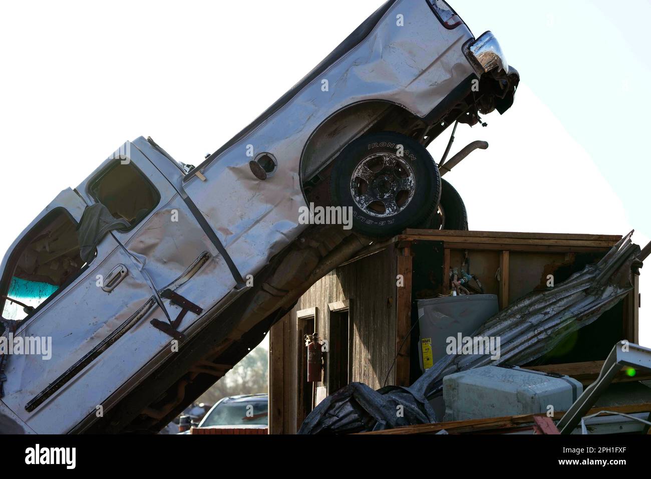 Wind-tossed vehicles, are piled onto another in Rolling Fork, Miss ...